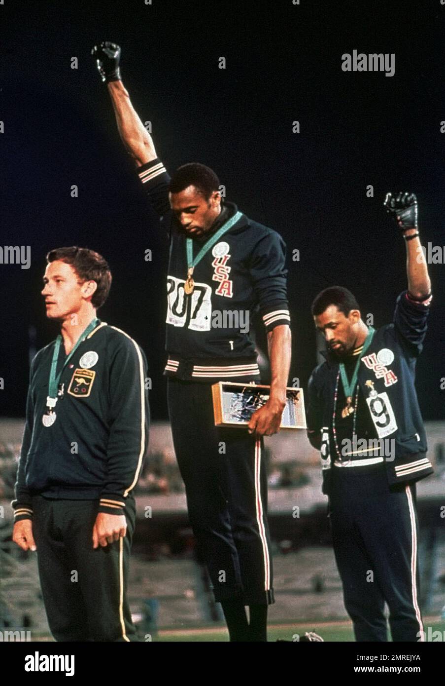 FILE - In this Oct. 16, 1968, file photo, extending gloved hands ...