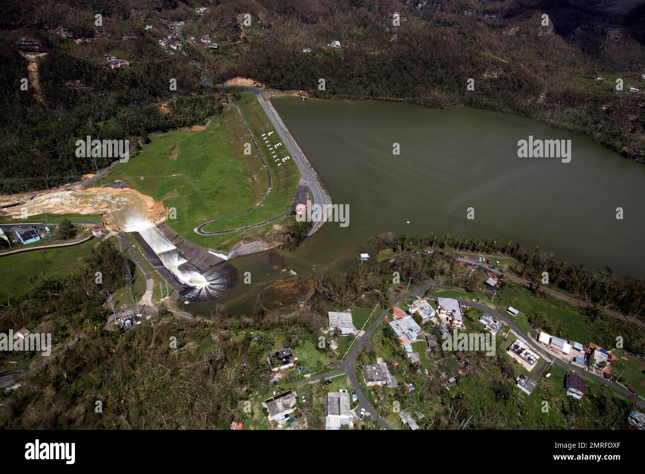 Water drains from the Guajataca Dam in Quebradillas, Puerto Rico ...
