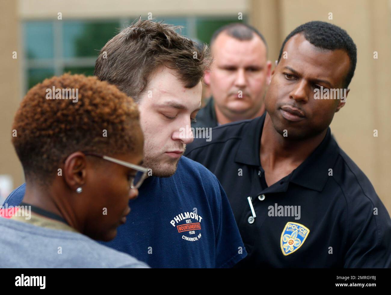Kenneth James Gleason is escorted by police to a waiting police car in ...