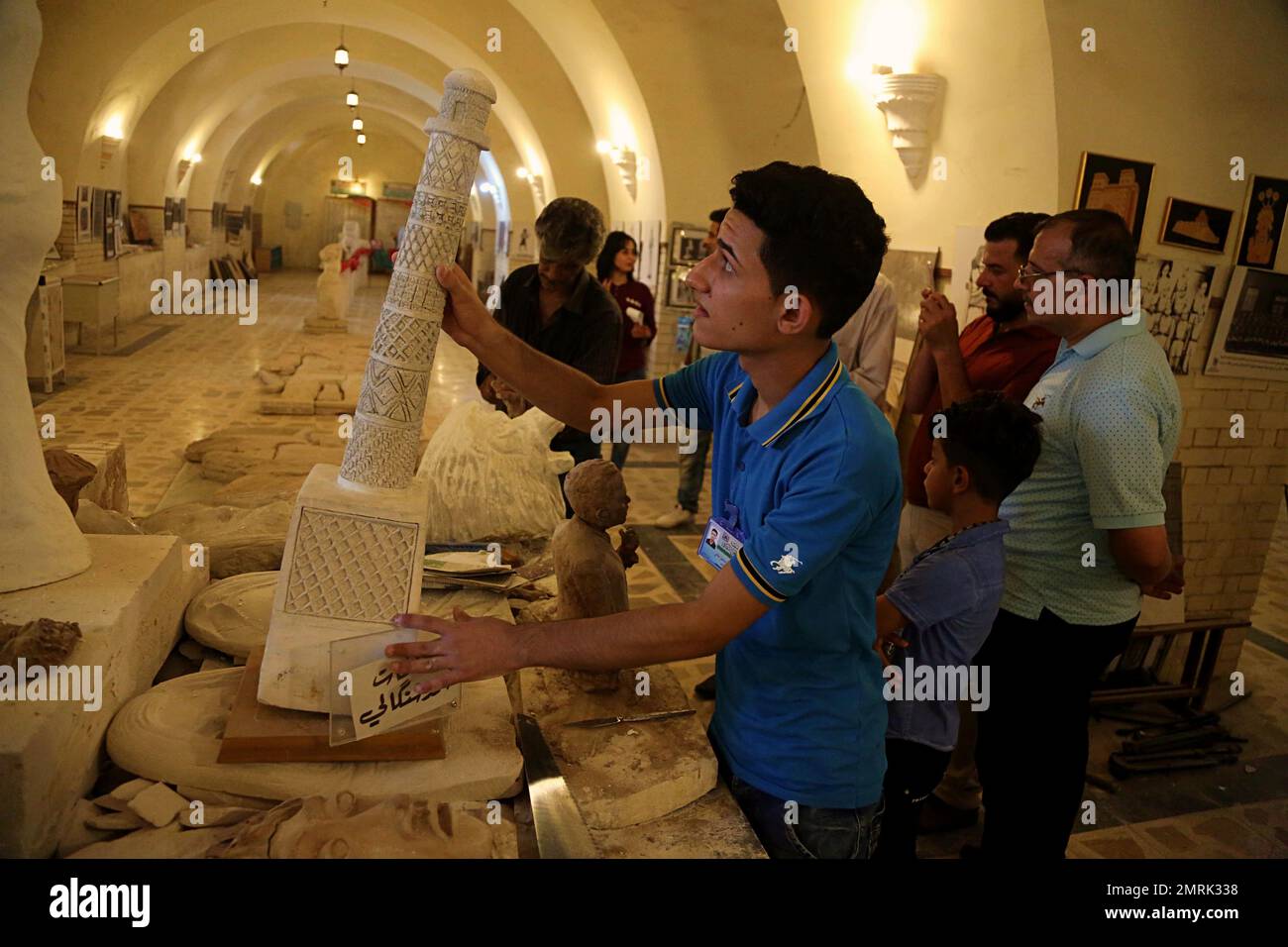 Ahmed Shinqali, center, a sculptor and stone carver from Mosul, Iraq ...