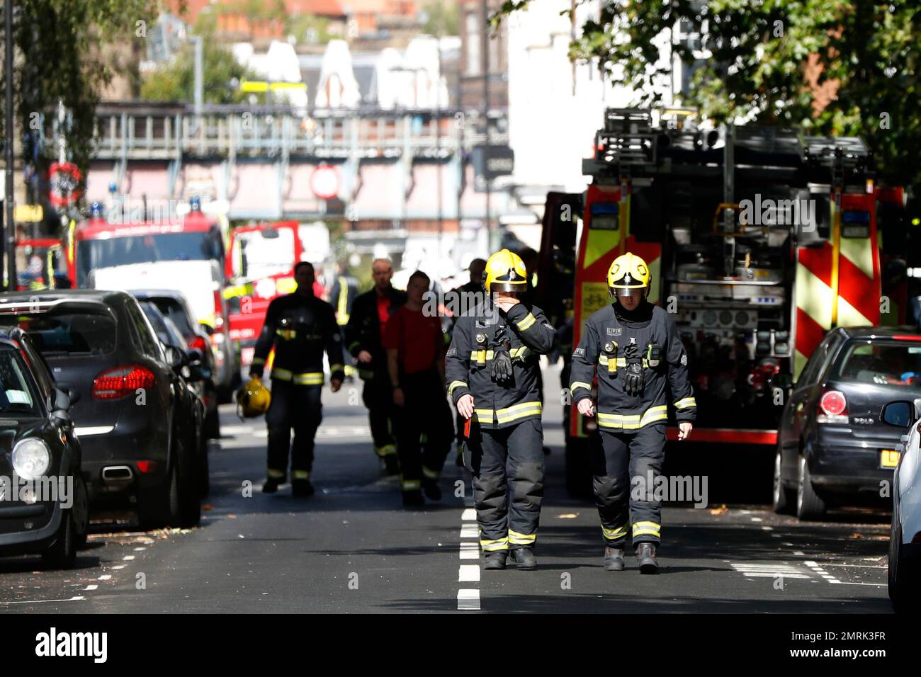 Fire brigade officers walk within a cordon near where an incident ...