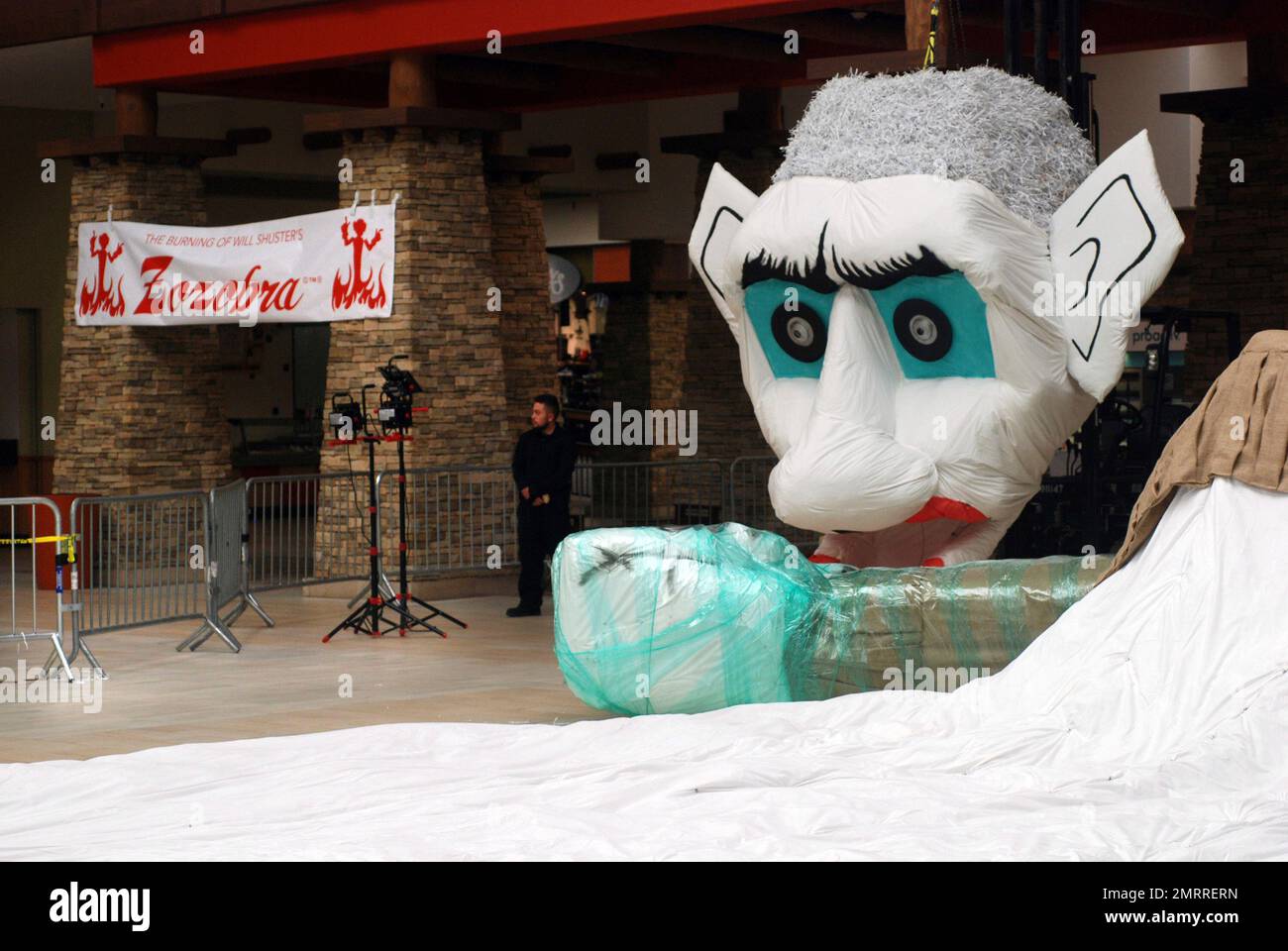 Shopping mall security guard David Maez keeps watch over pieces of a ...
