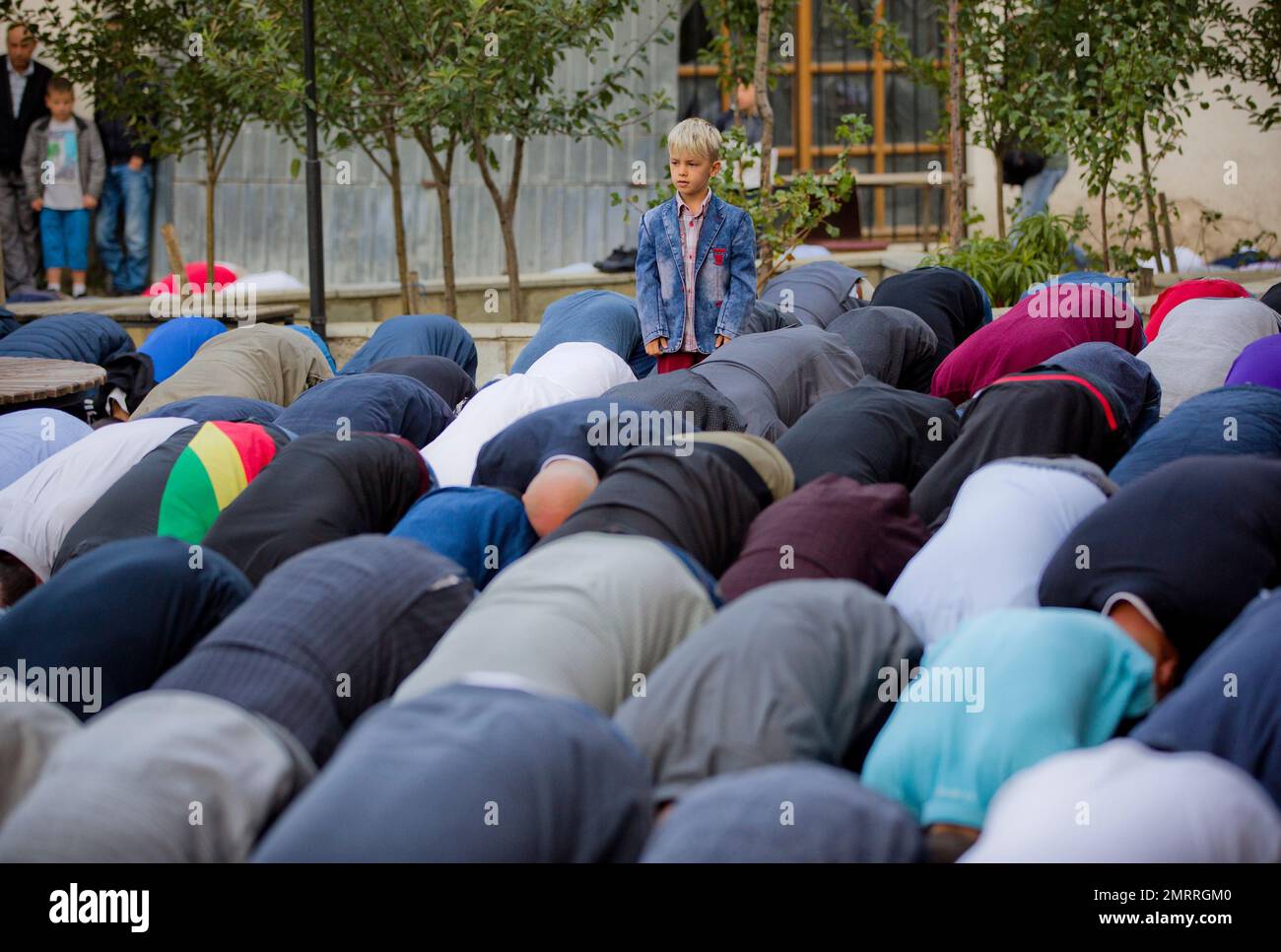 A Kosovar boy stands during Eid al-Adha prayers outside the Sultan Mehmet Fatih mosque in ...