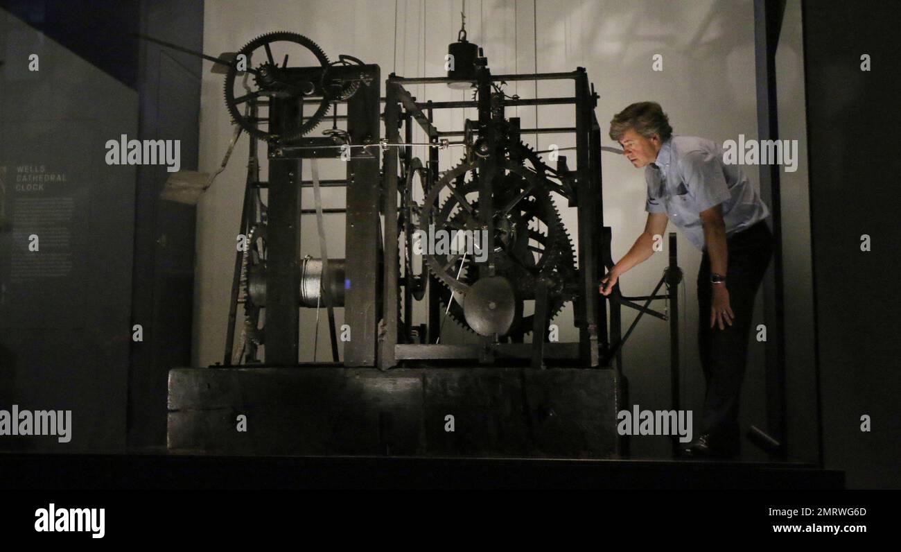 A museum employee checks the Wells Cathedral clock mechanism, on ...