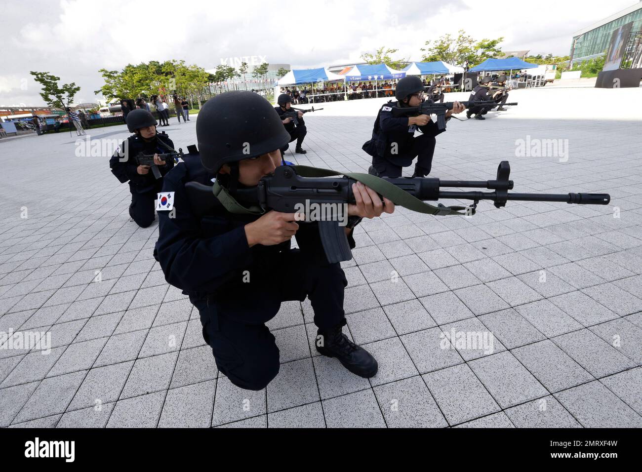 South Korean police officers aim their machine guns during an anti ...