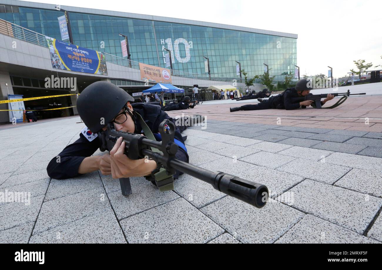 South Korean police officers aim their machine guns during an anti ...