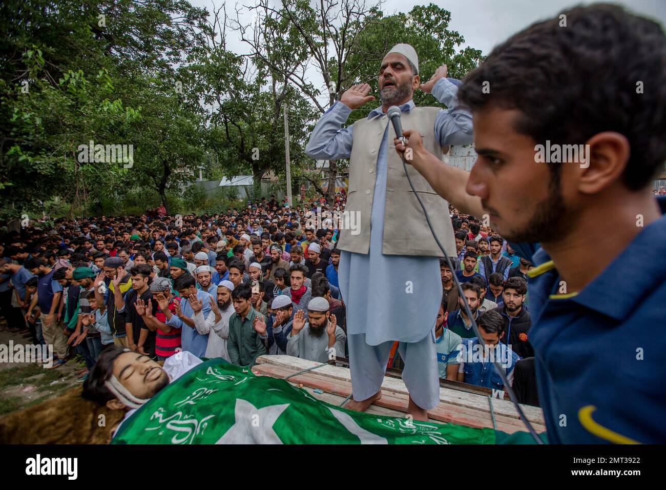 Kashmiri villagers offer prayers near the body of Akeel Ahmed, a ...