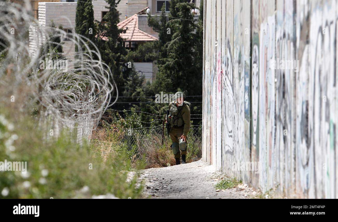 An Israeli soldier is seen near the separation barrier in Bethlehem PSE ...