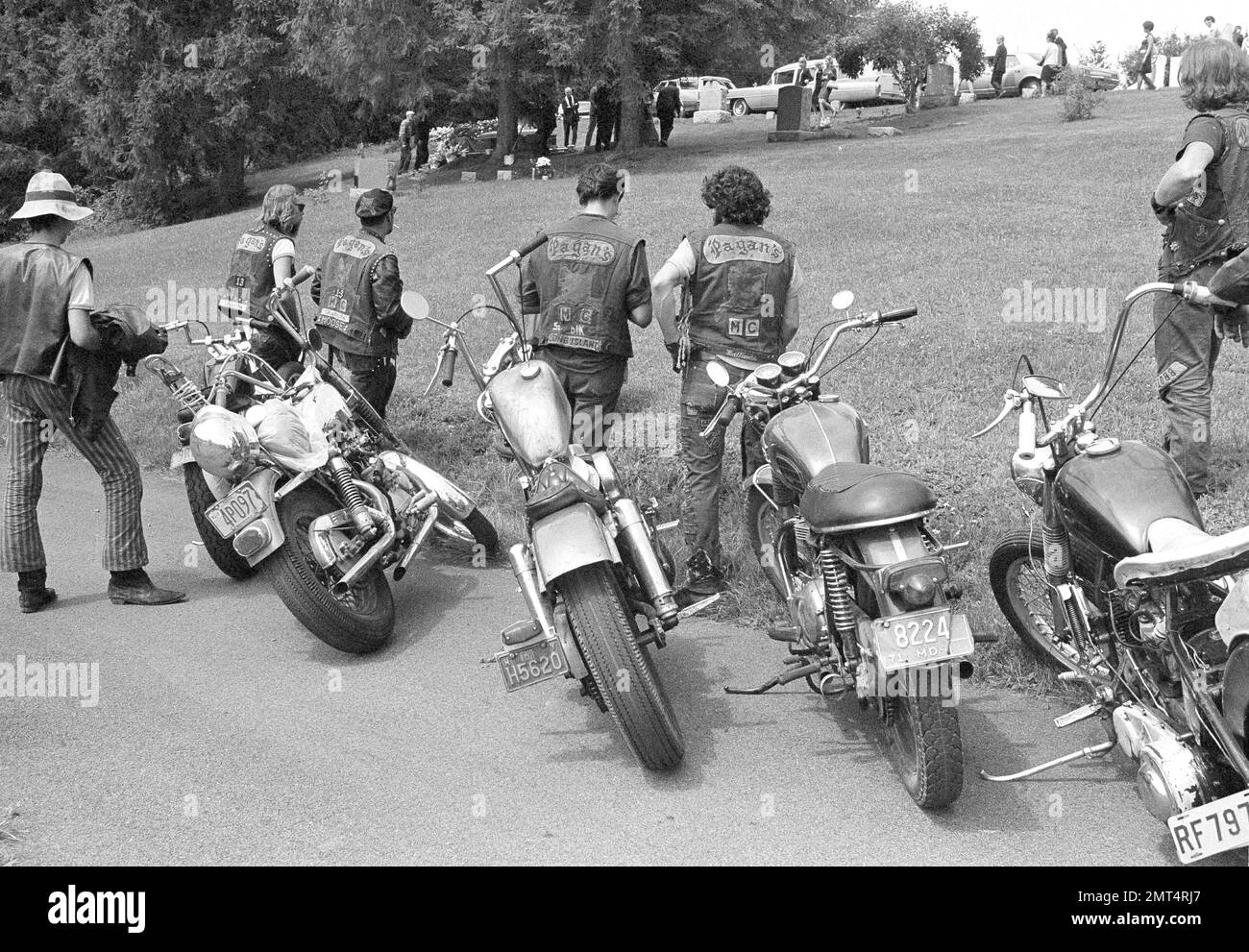 Members of the Pagans motorcycle gang wait for a priest to conclude ...