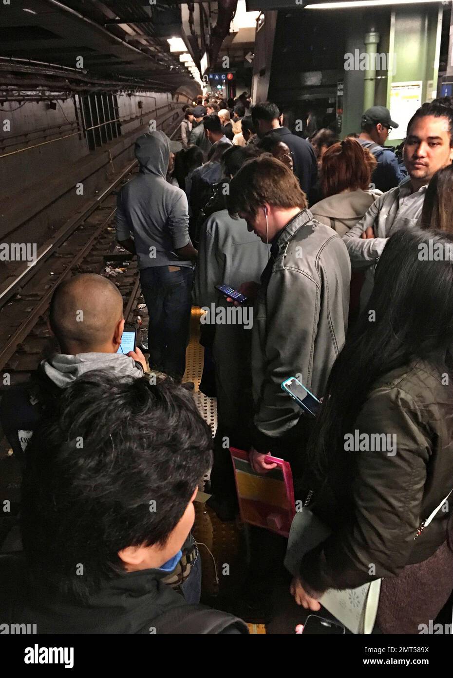 FILE- In this April 21, 2017 file photo, commuters crowd the subway ...