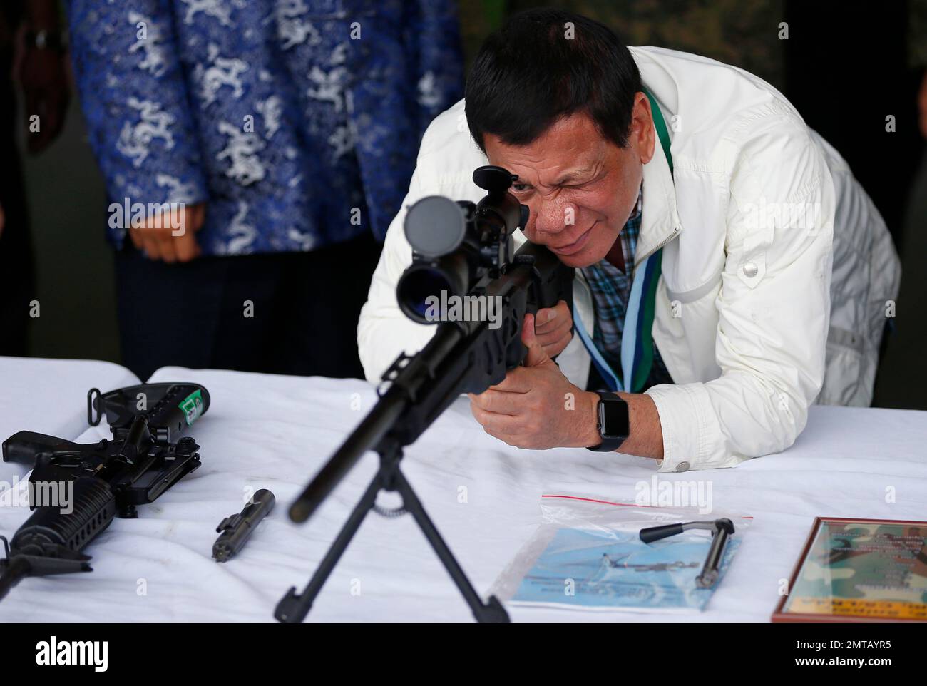 Philippine President Rodrigo Duterte checks the scope of a Chinese-made ...