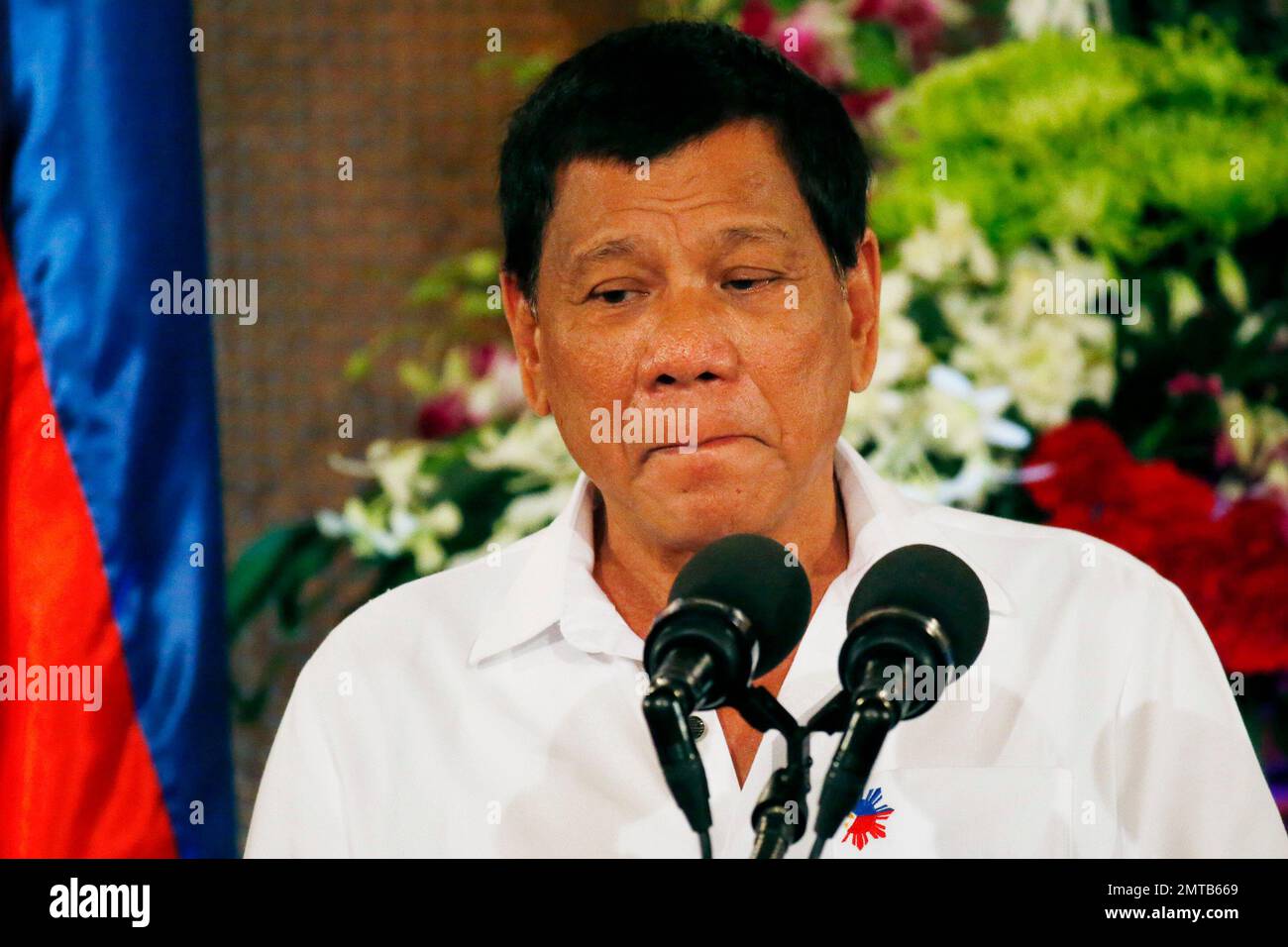 Philippine President Rodrigo Duterte reacts while addressing Filipino ...
