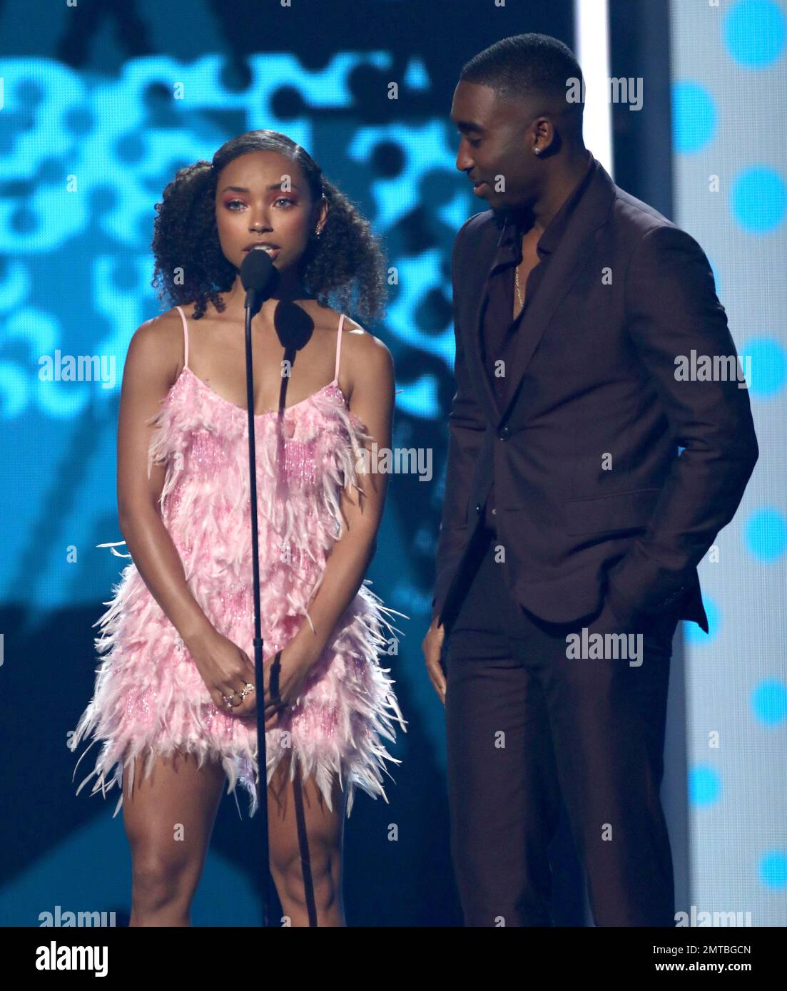 Logan Browning, left, and Demetrius Shipp Jr. present the award for ...