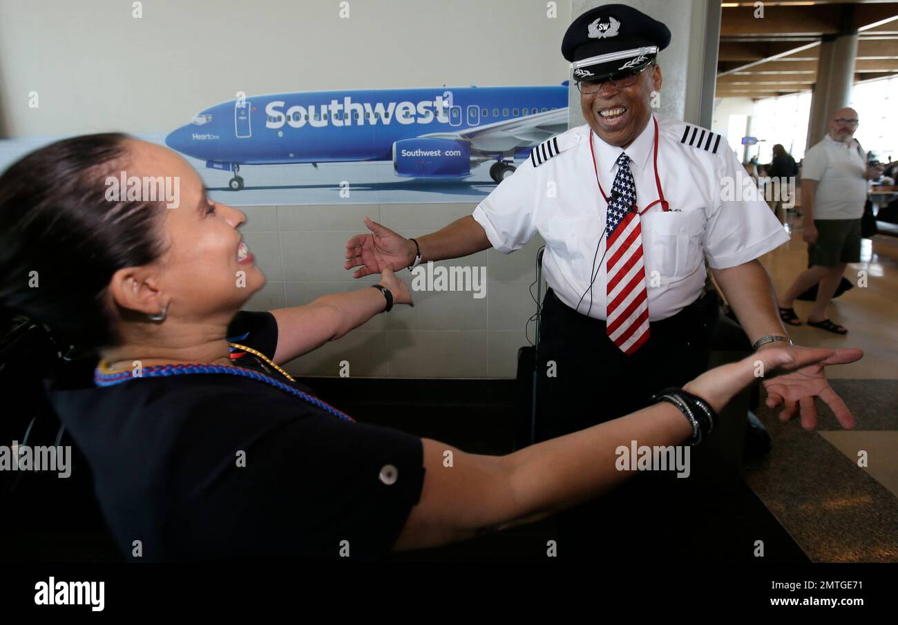 Southwest Airlines captain Louis Freeman, right, gets a hug from flight ...