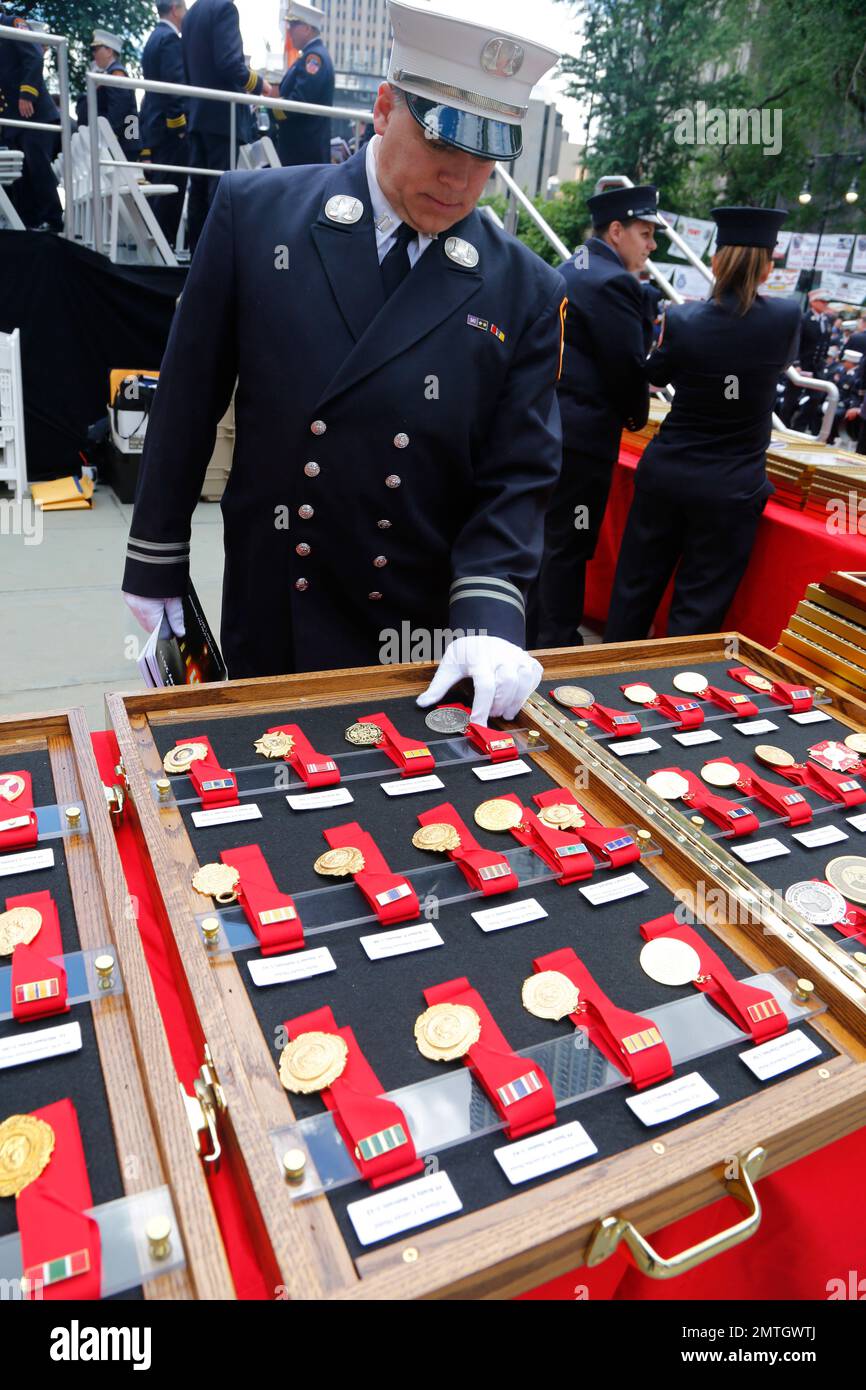 Capt. Ray Arcos rests his hand next to a display of medals during the ...