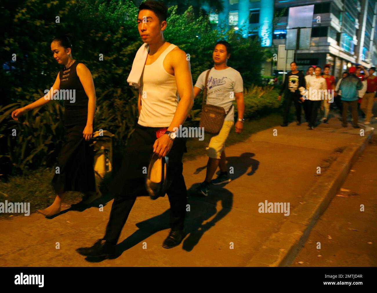 Hotel guests and employees, one barefoot at left, leave the Resorts ...