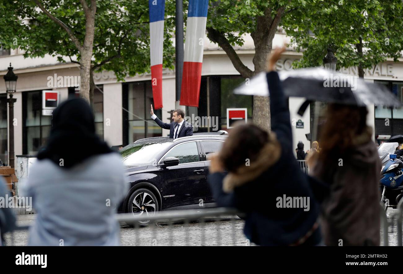 New French President Emmanuel Macron waves to the crowds, as he is ...