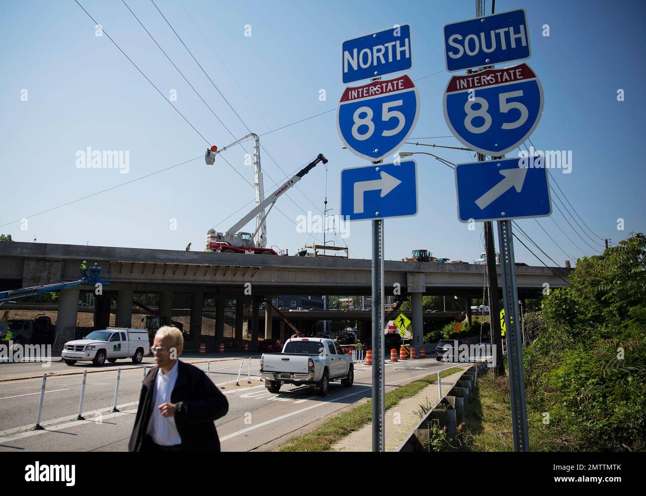 Construction crews work on a repaired section of an overpass that ...