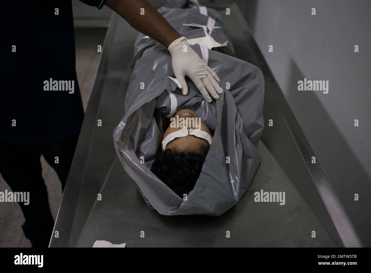 FILE - In this Feb. 4, 2017 file photo, a morgue worker prepares the ...