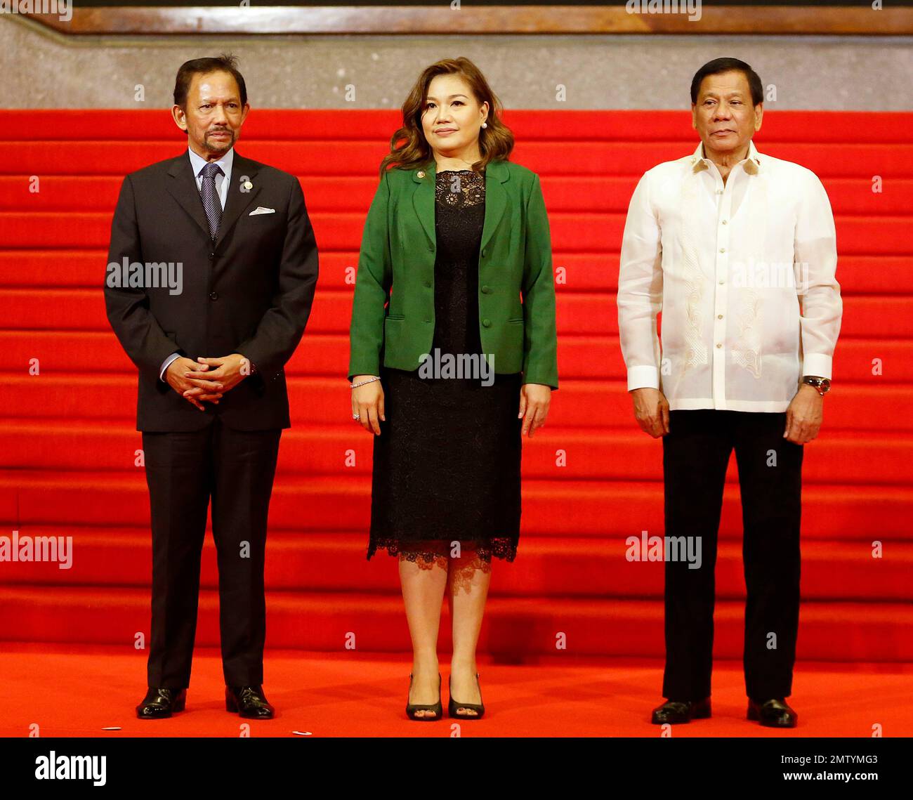Sultan Hassanal Bolkiah of Brunei Darussalam, left, poses with Honeylet Avancena, center, the ...