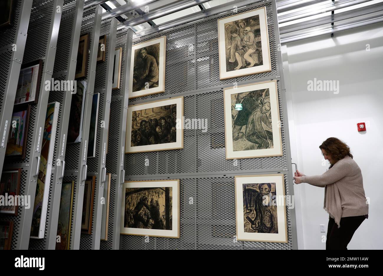 Laura Seylar, registrar of Collections Management, slides open a ...