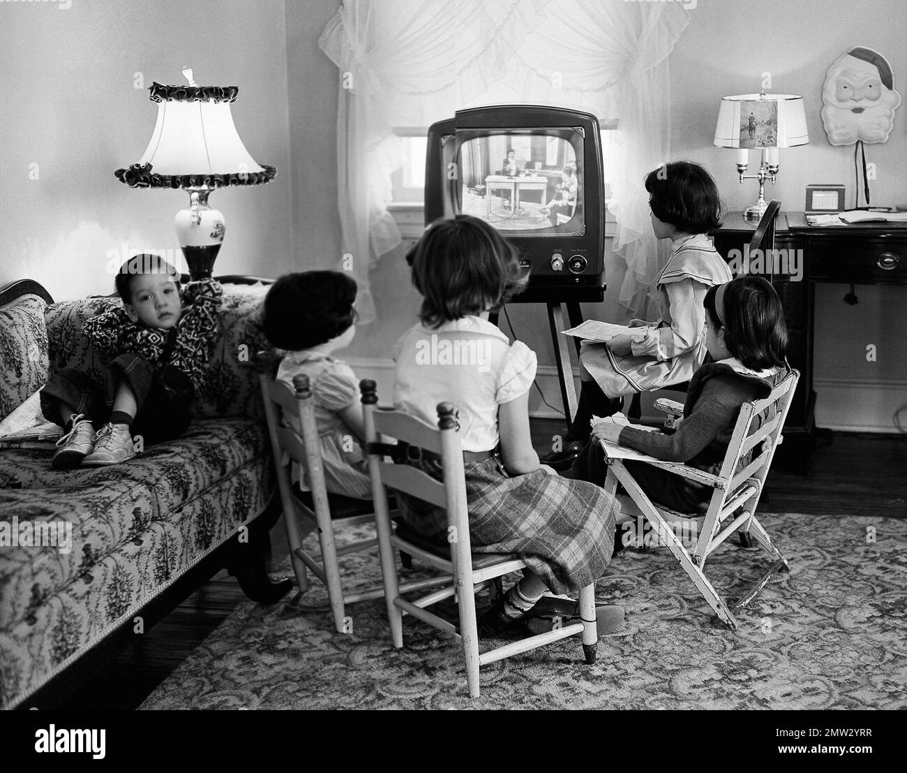 FILE - In this Jan. 6, 1953, file photo, four children watch a ...