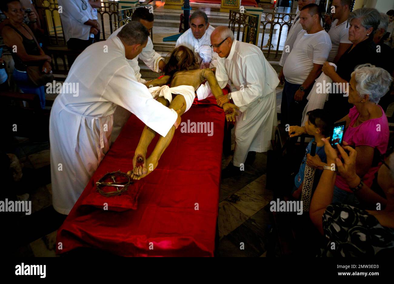Altar servers carry a statue of Jesus Christ before a Holy Week procession on Good Friday in ...