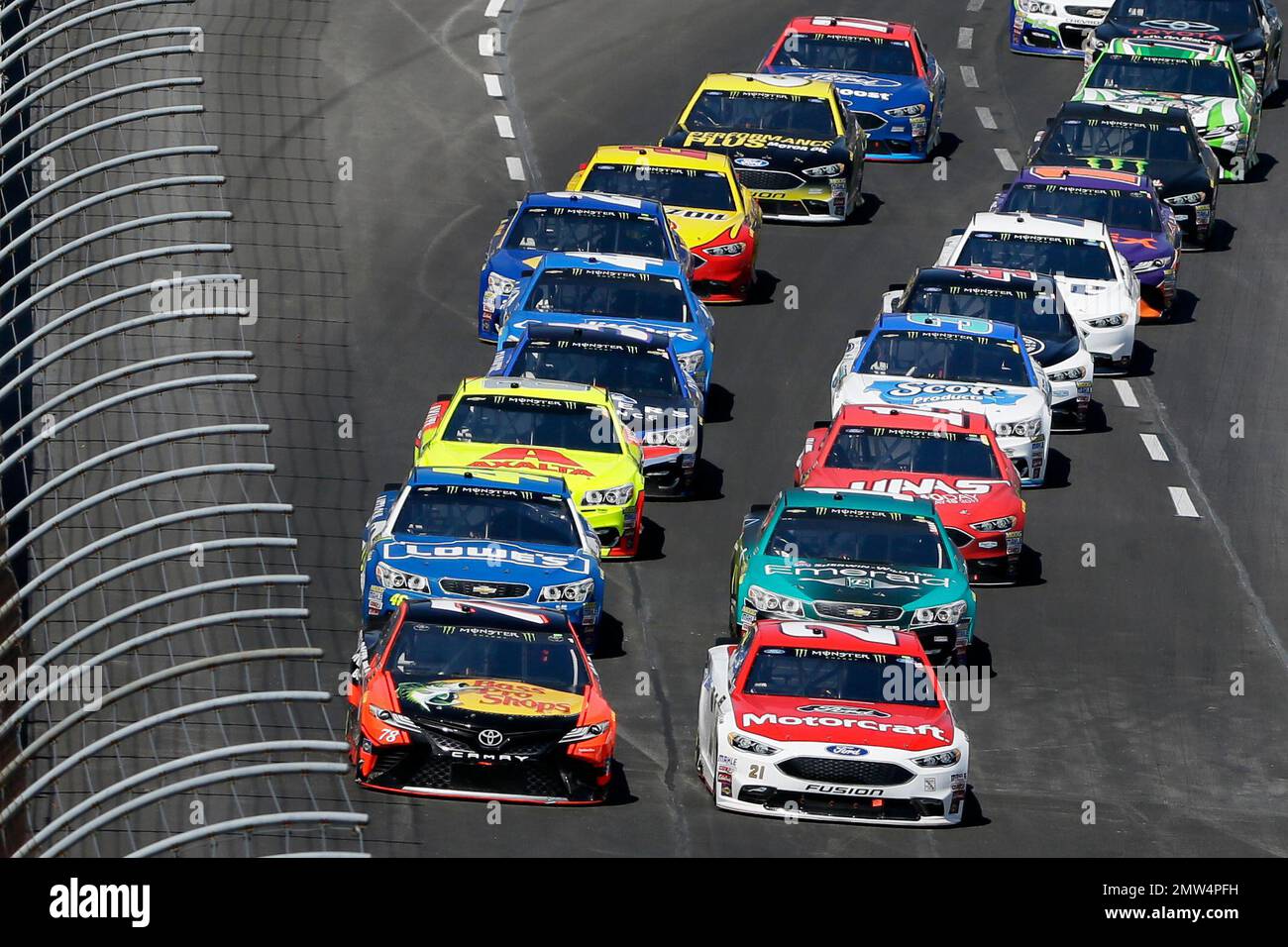 Martin Truex Jr., left, front, and Ryan Blaney, right front, lead ...