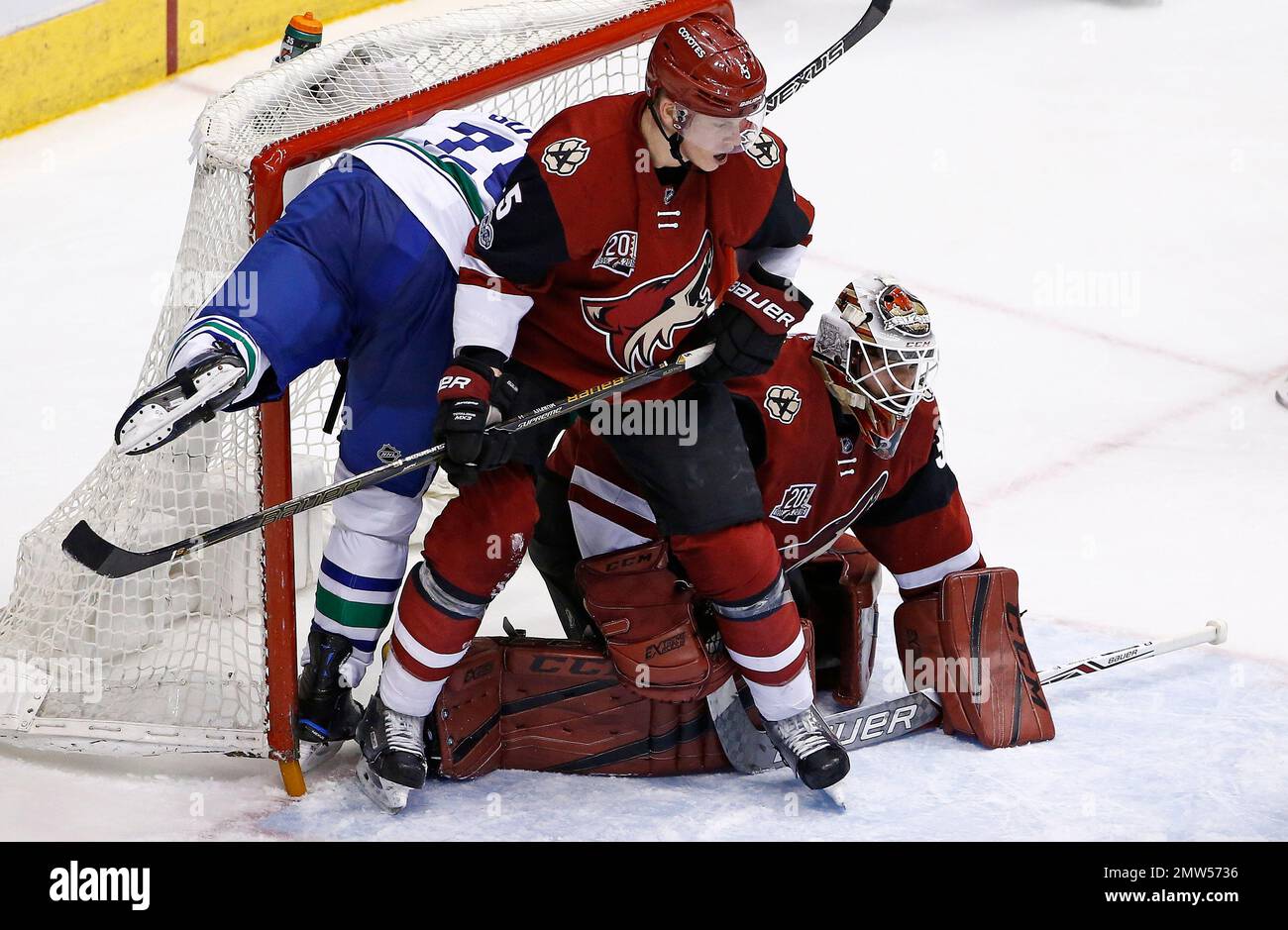 Arizona Coyotes' Connor Murphy (5) backs Vancouver Canucks' Brandon ...