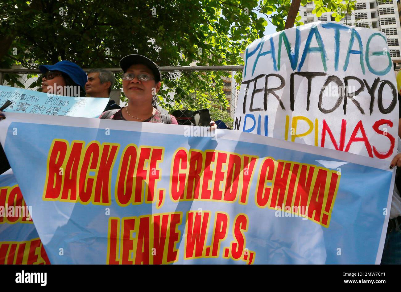 Protesters display placards in front of the Chinese Consulate to ...