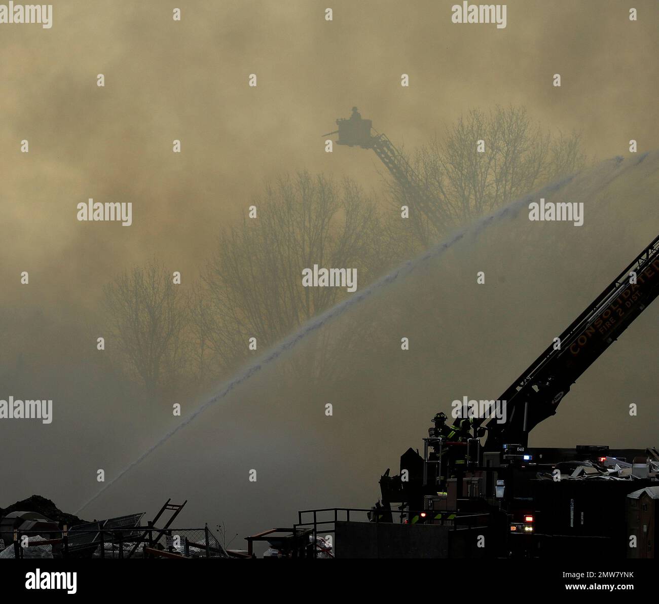Firefighters fight an eight-alarm fire that began at an apartment ...
