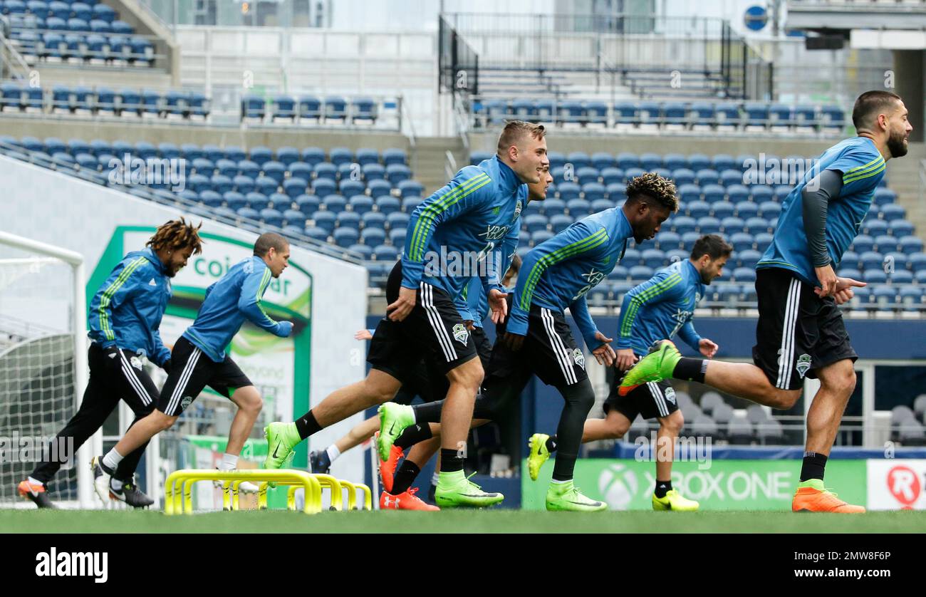 Seattle Sounders forward Clint Dempsey, right, runs during a training ...
