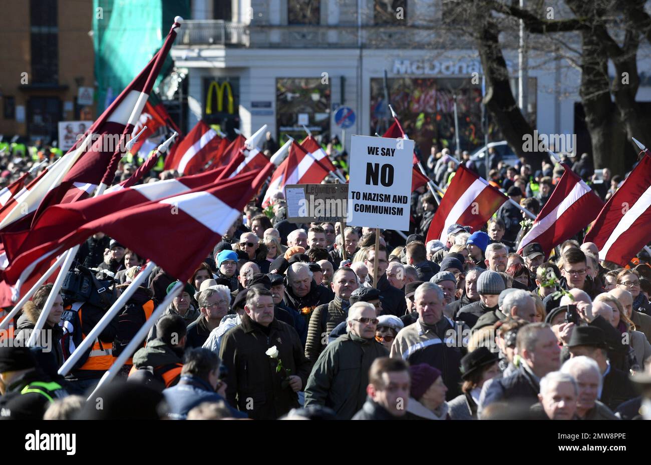 People, with Latvian flags, march to the Freedom Monument to honor ...