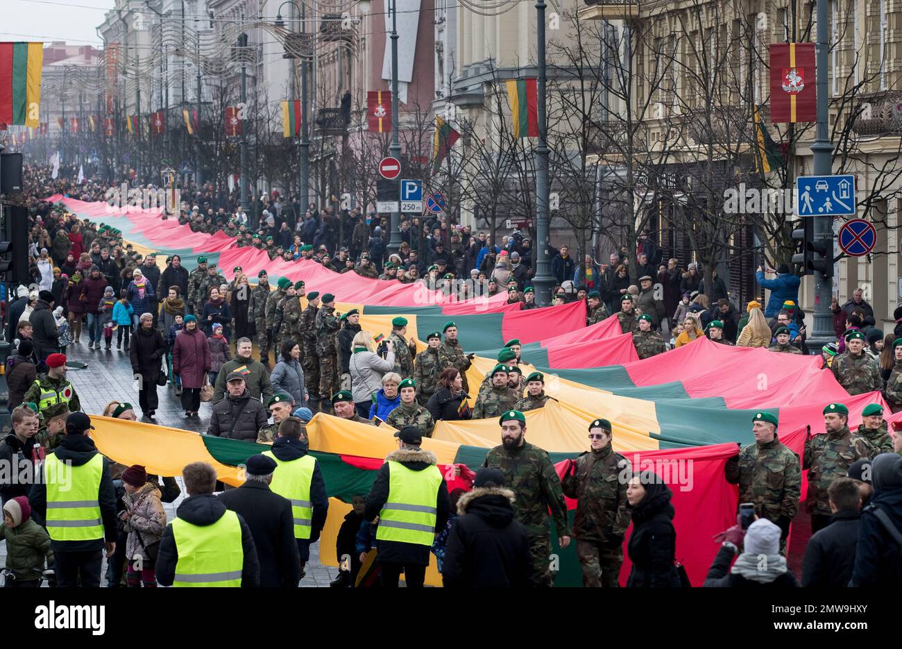 People carry a giant Lithuanian flag during a celebration of Lithuania ...