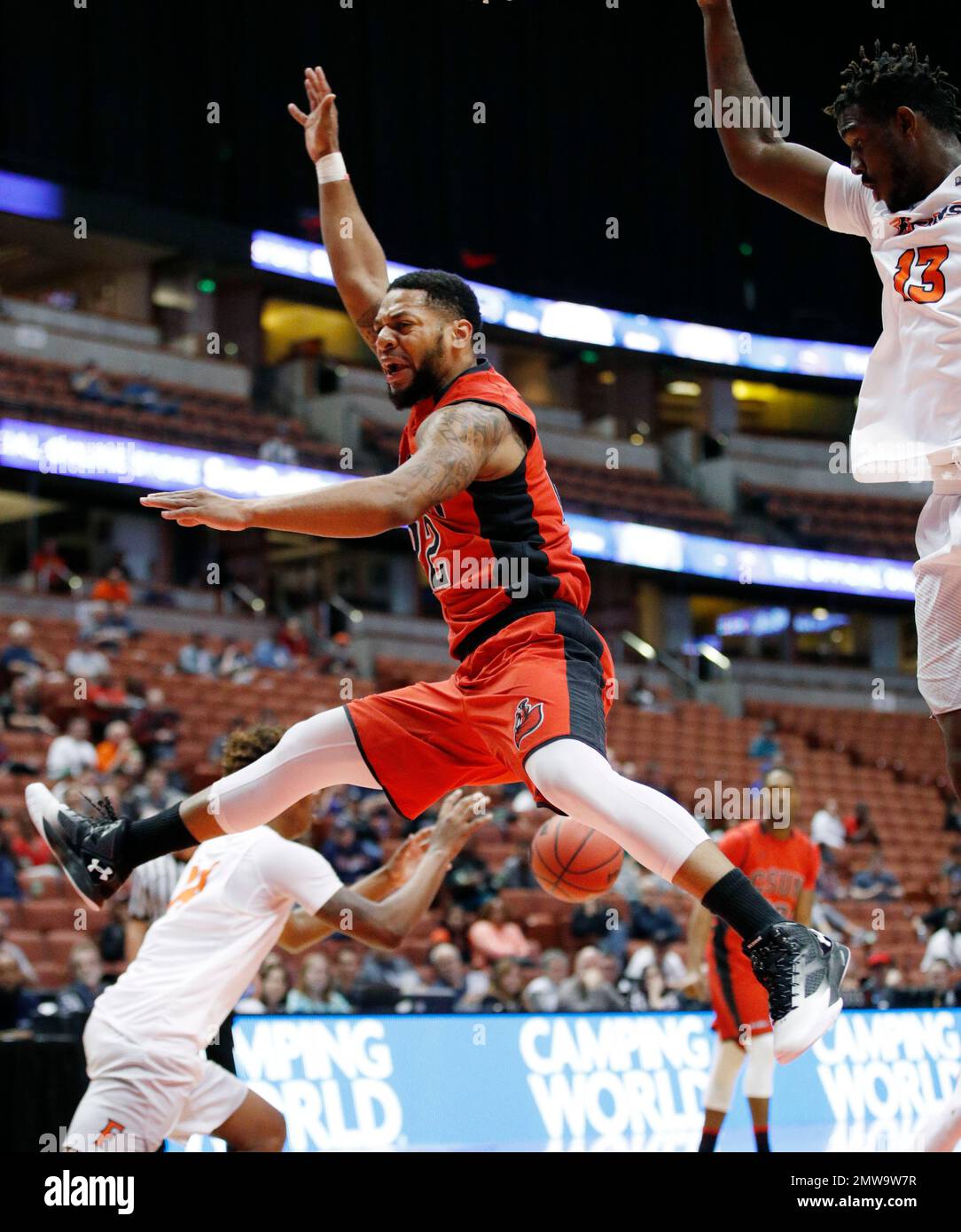 Cal State Northridge's Aaron Parks, center, loses the ball after he was ...