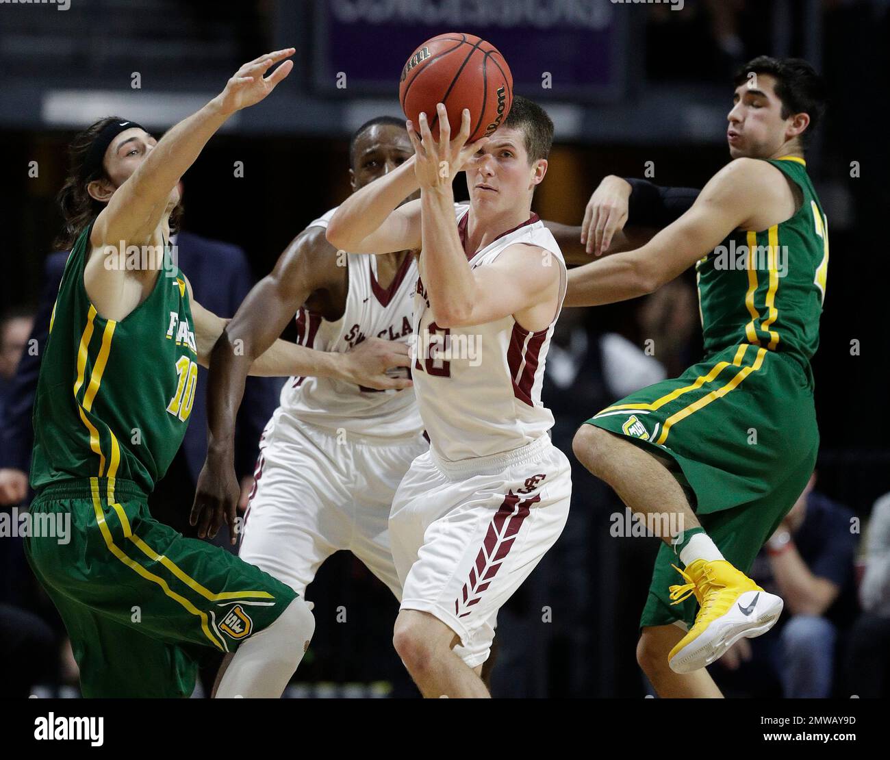 Santa Clara's Matt Hauser, center, battles for the ball with San ...