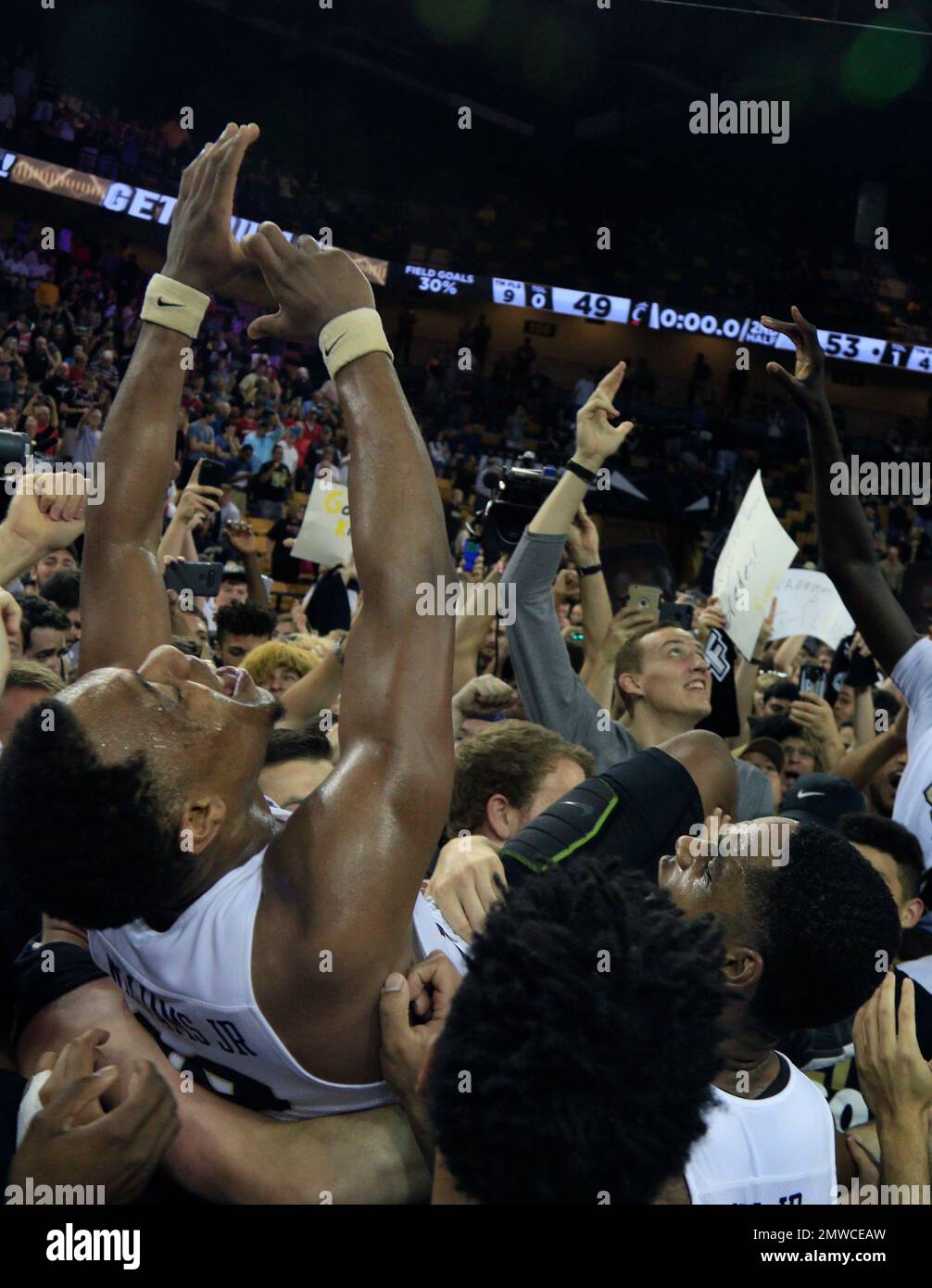 Central Florida guard Matt Williams, center, is lifted by players and ...