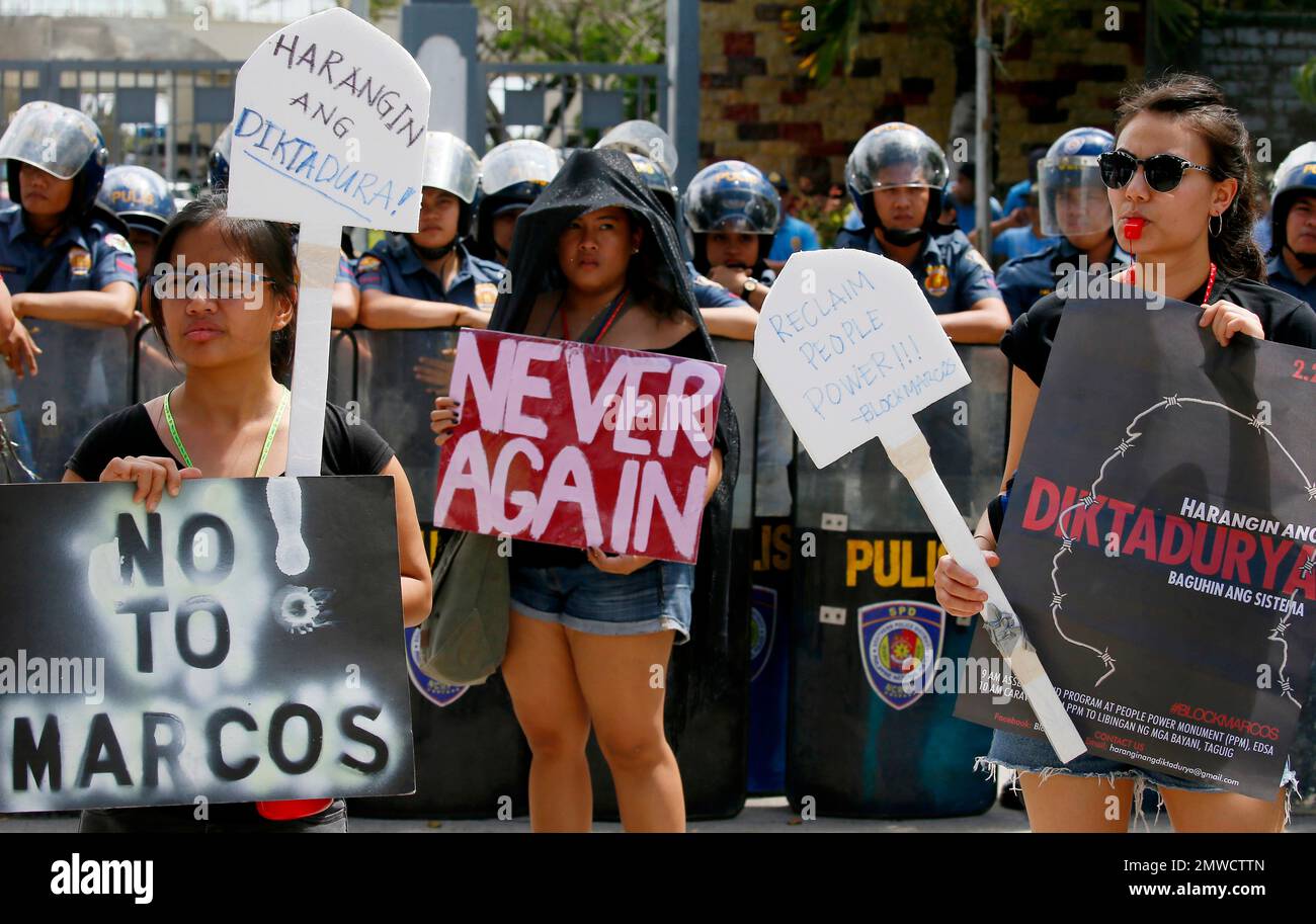 Protesters display placards during a rally at the Heroes Cemetery to ...
