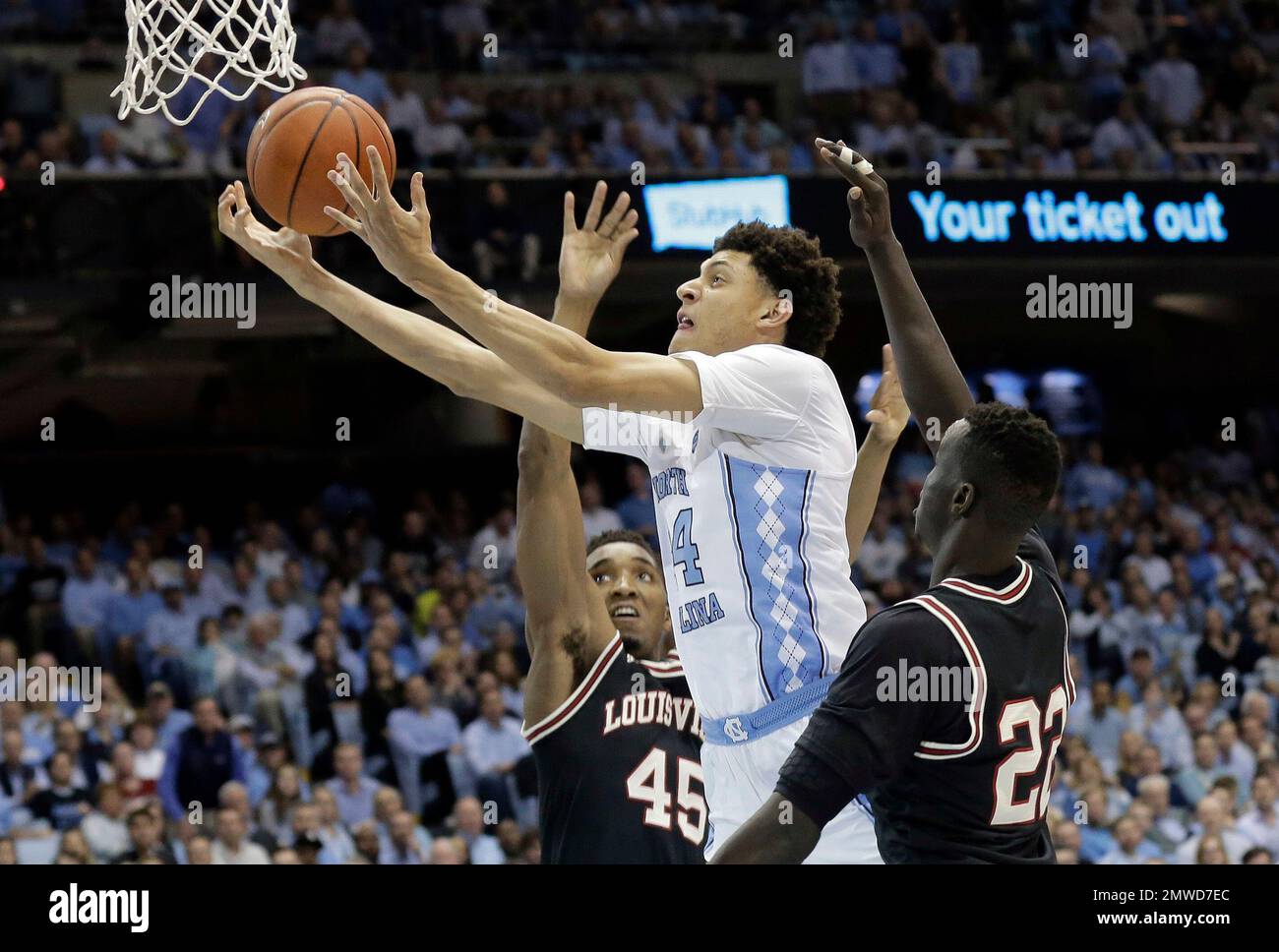 North Carolina's Justin Jackson (44) drives between Louisville's ...