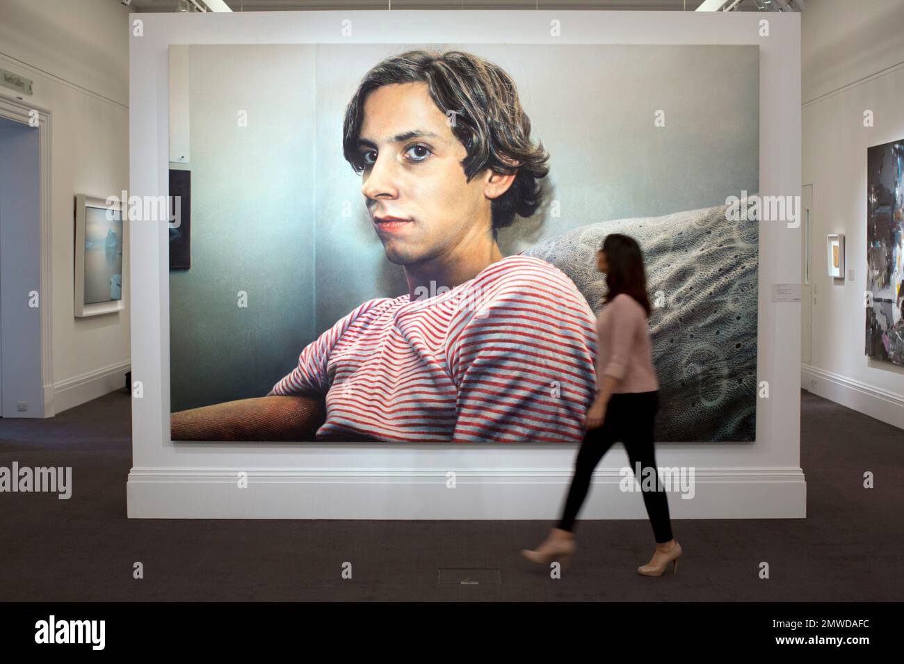 A member of Sotheby's auction house staff poses for photographers next to Swiss artist Franz ...