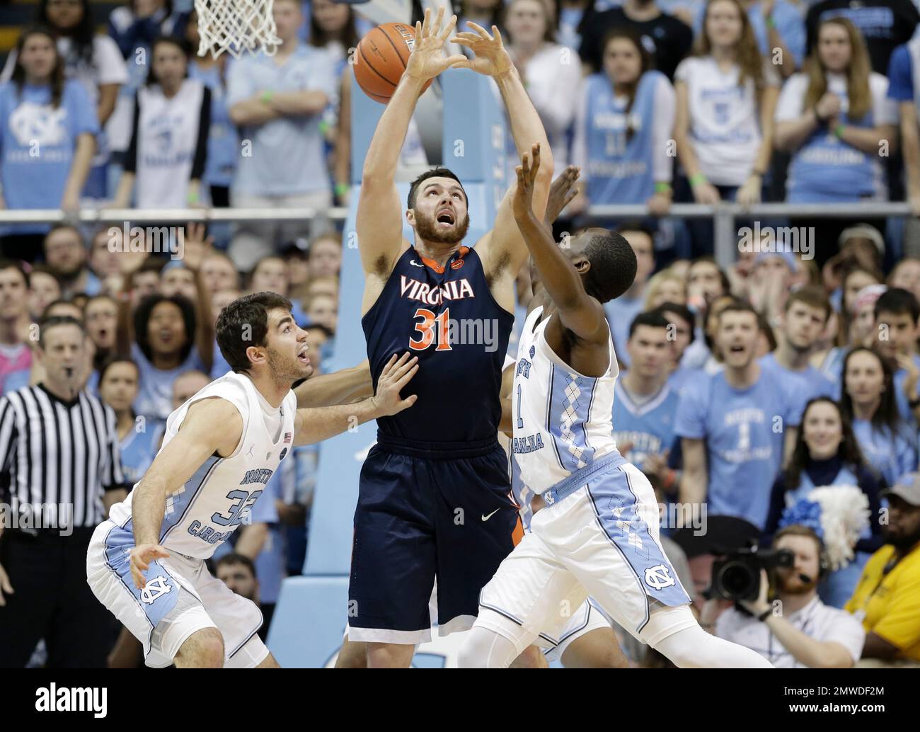 North Carolina's Luke Maye, left, and Theo Pinson chase a rebound with ...