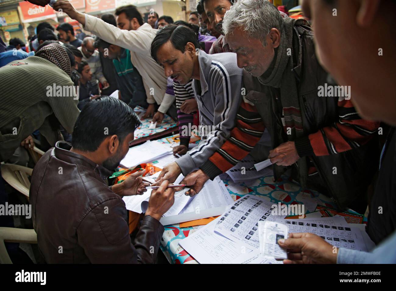 Indian voters crowd to check their names in electoral lists outside a ...