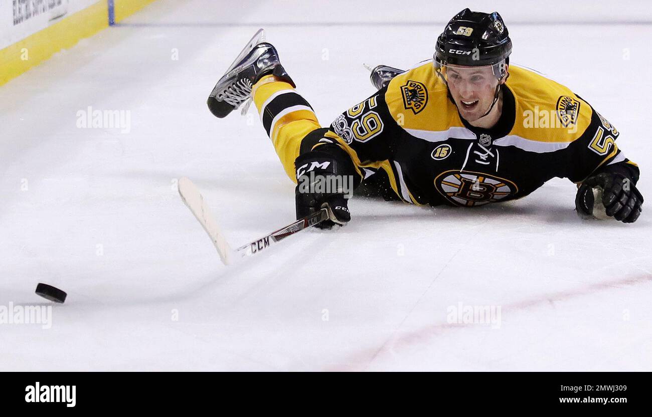 Boston Bruins center Tim Schaller (59) slides after the puck against ...