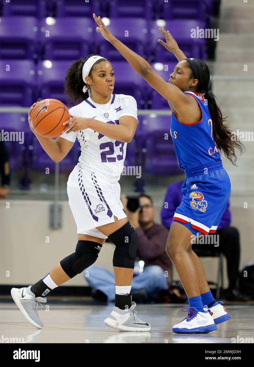 TCU guard AJ Alix (23) looks to make a pass as Kansas' McKenzie Calvert ...