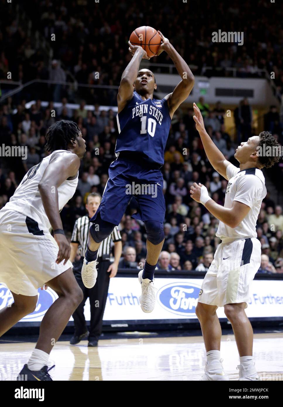 Penn State guard Tony Carr (10) shoots over Purdue center Isaac Haas ...