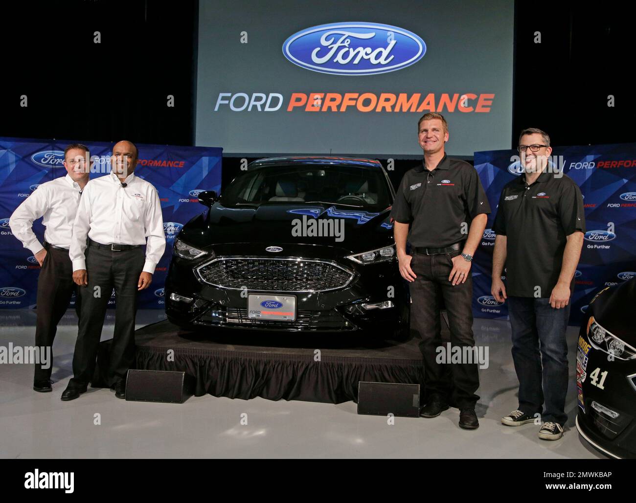 Team owner Tony Stewart, right, poses with driver Clint Bowyer, second ...