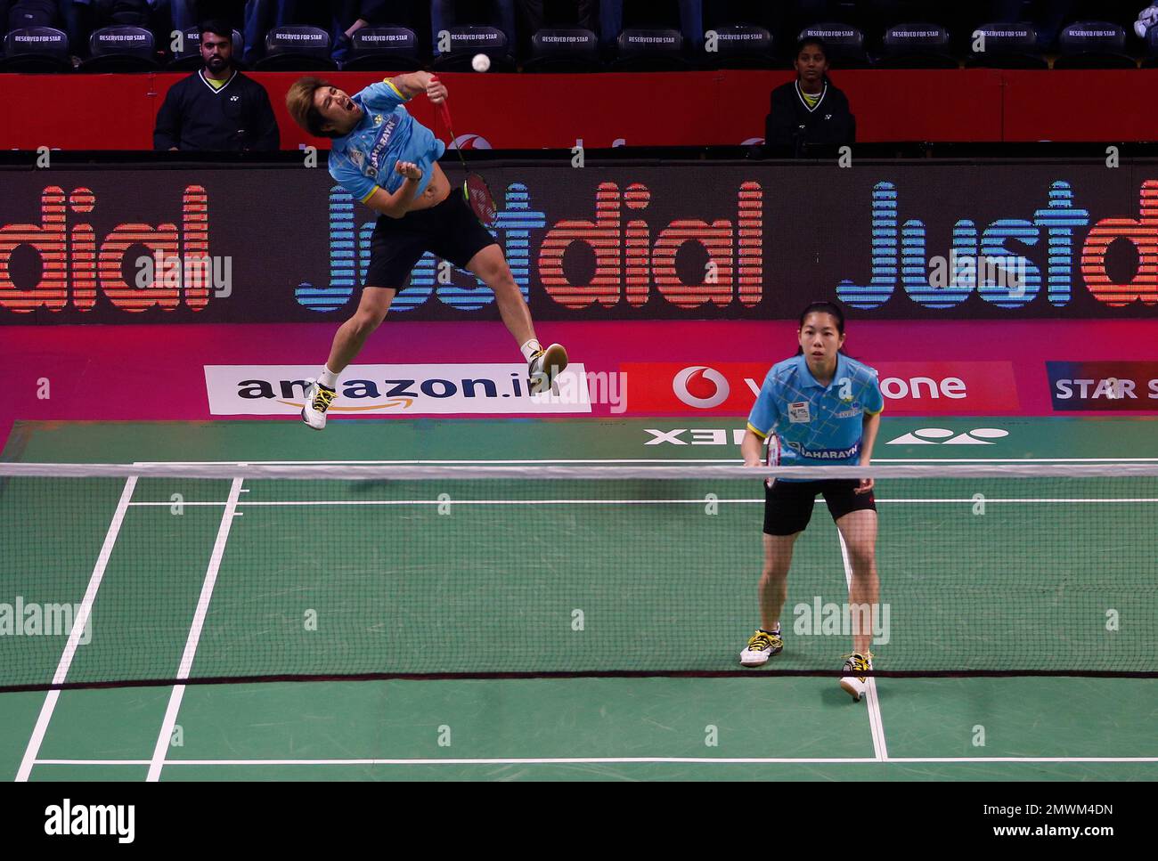 Thai badminton player Bodin Isara plays a shot with compatriot Savitree ...