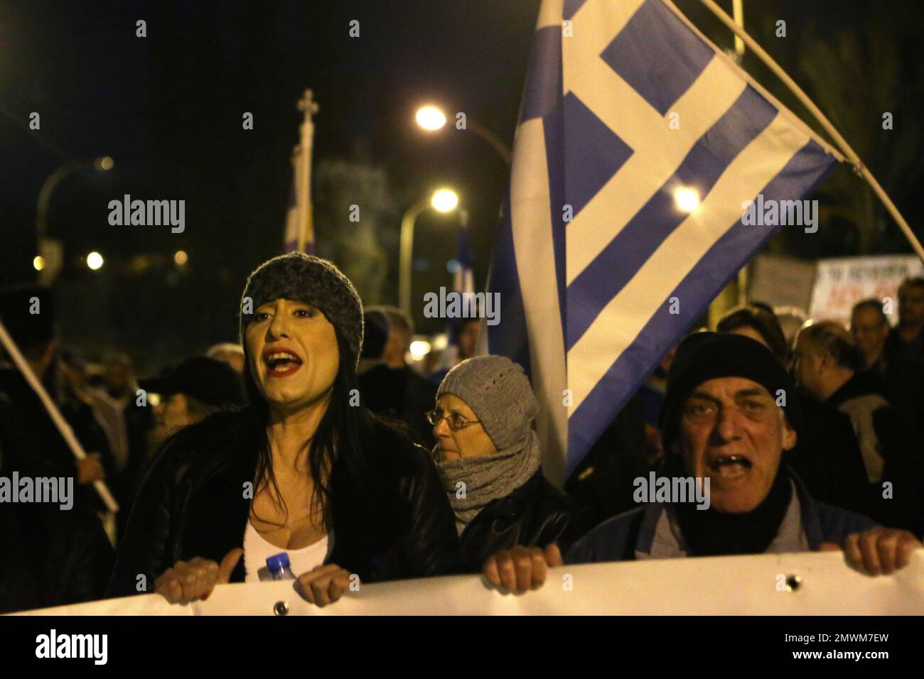 Protestors shout slogans and wave Greek flags during a protest against ...