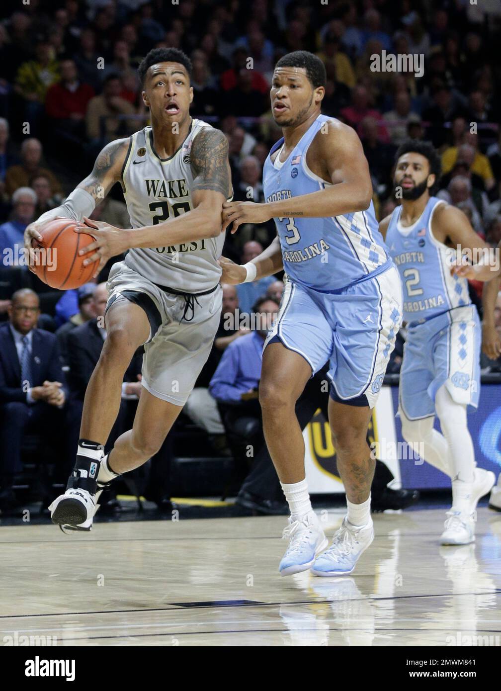 Wake Forest's John Collins (20) drives against North Carolina's Kennedy ...