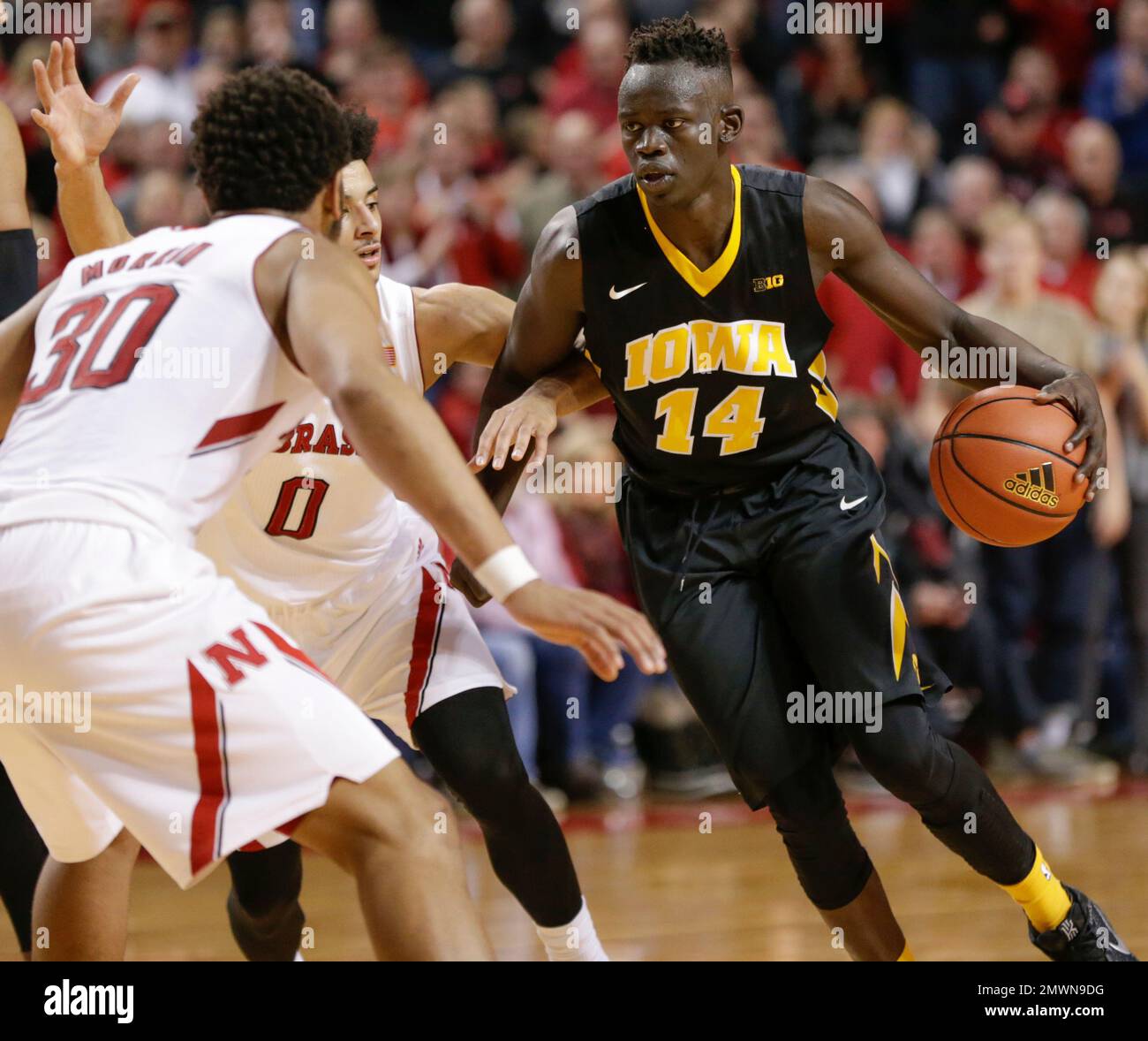 Iowa's Peter Jok (14) is defended by Nebraska's Tai Webster (0) and Ed ...